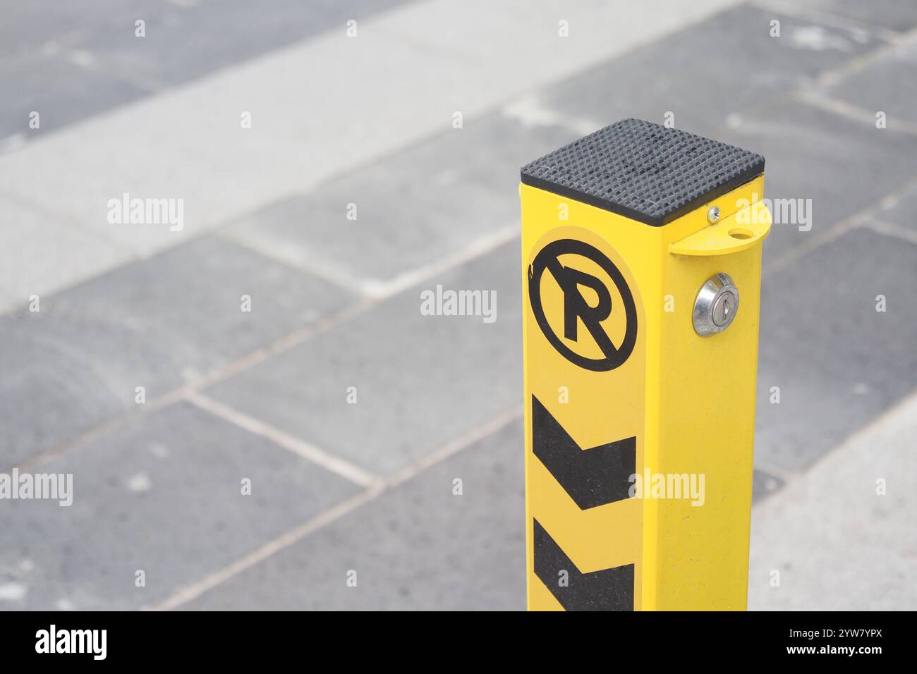 Yellow No Parking Post With Arrows On Paved Urban Street Stock Photo ...