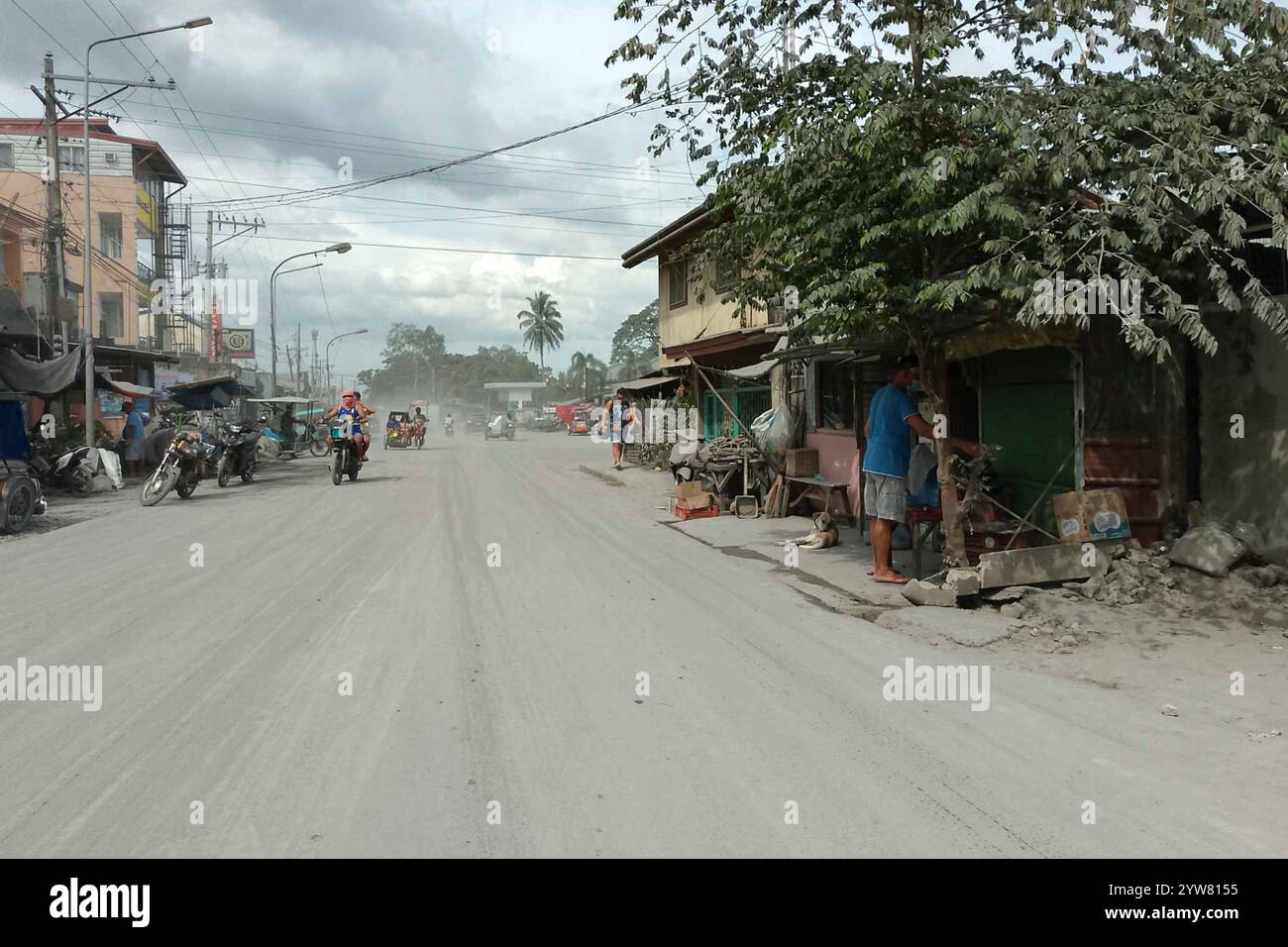 Volcanic ash covers a street at Bago City, Negros Occidental province ...