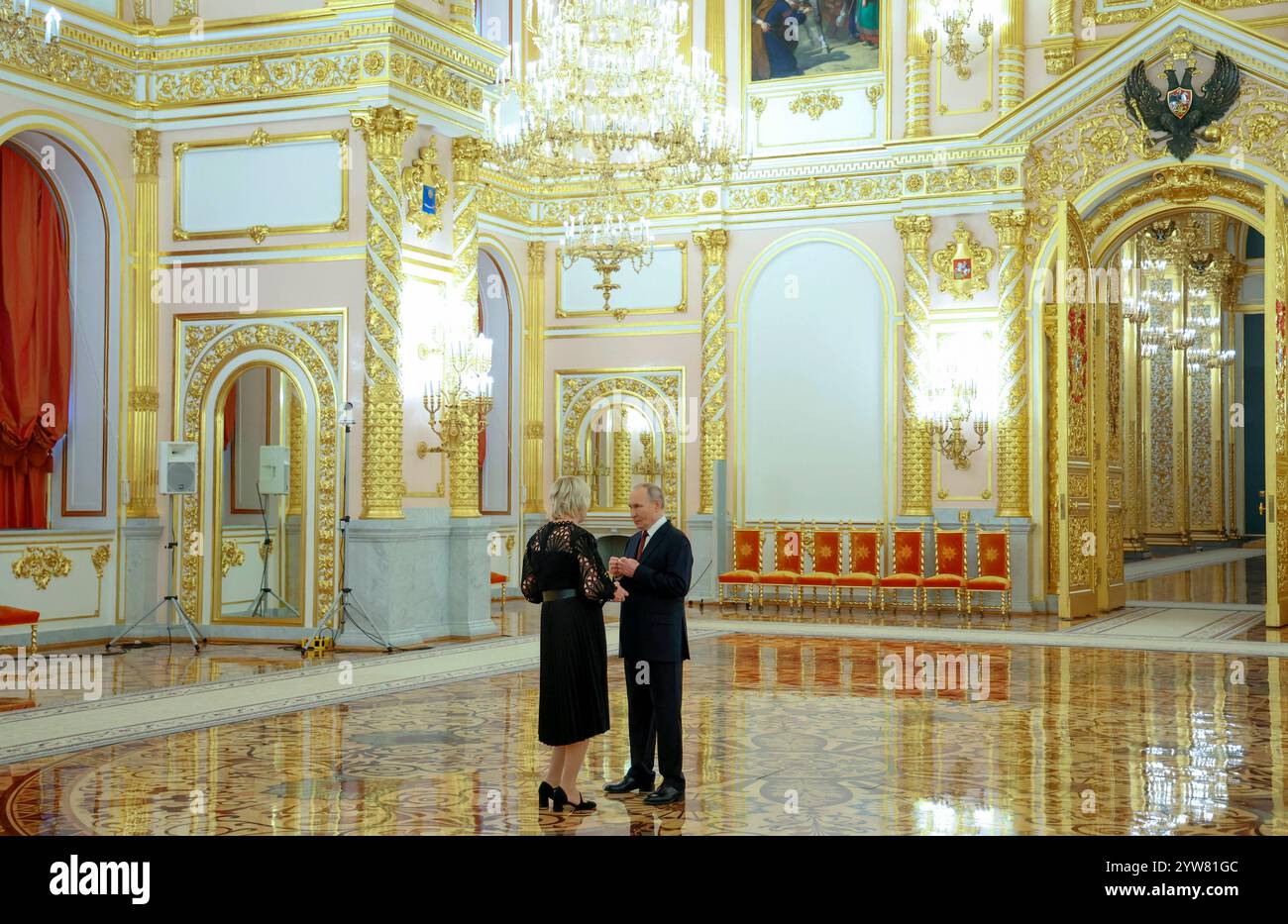 Russian President Vladimir Putin talks with widow of volunteer Vladimir Gavrilenko, posthumously ...