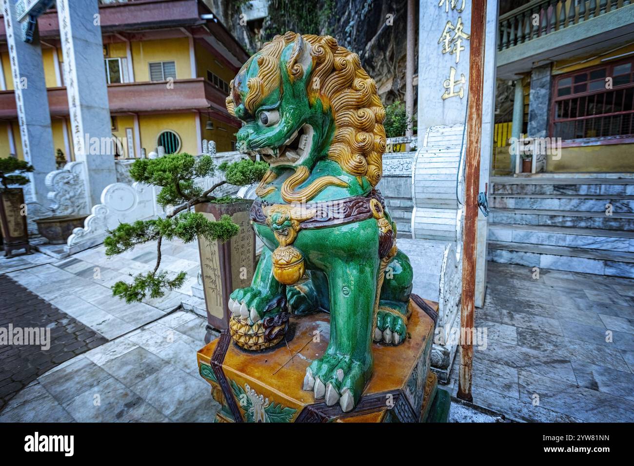 Lion statue at the entrance to Sam Poh Tong temple hidden in the ...