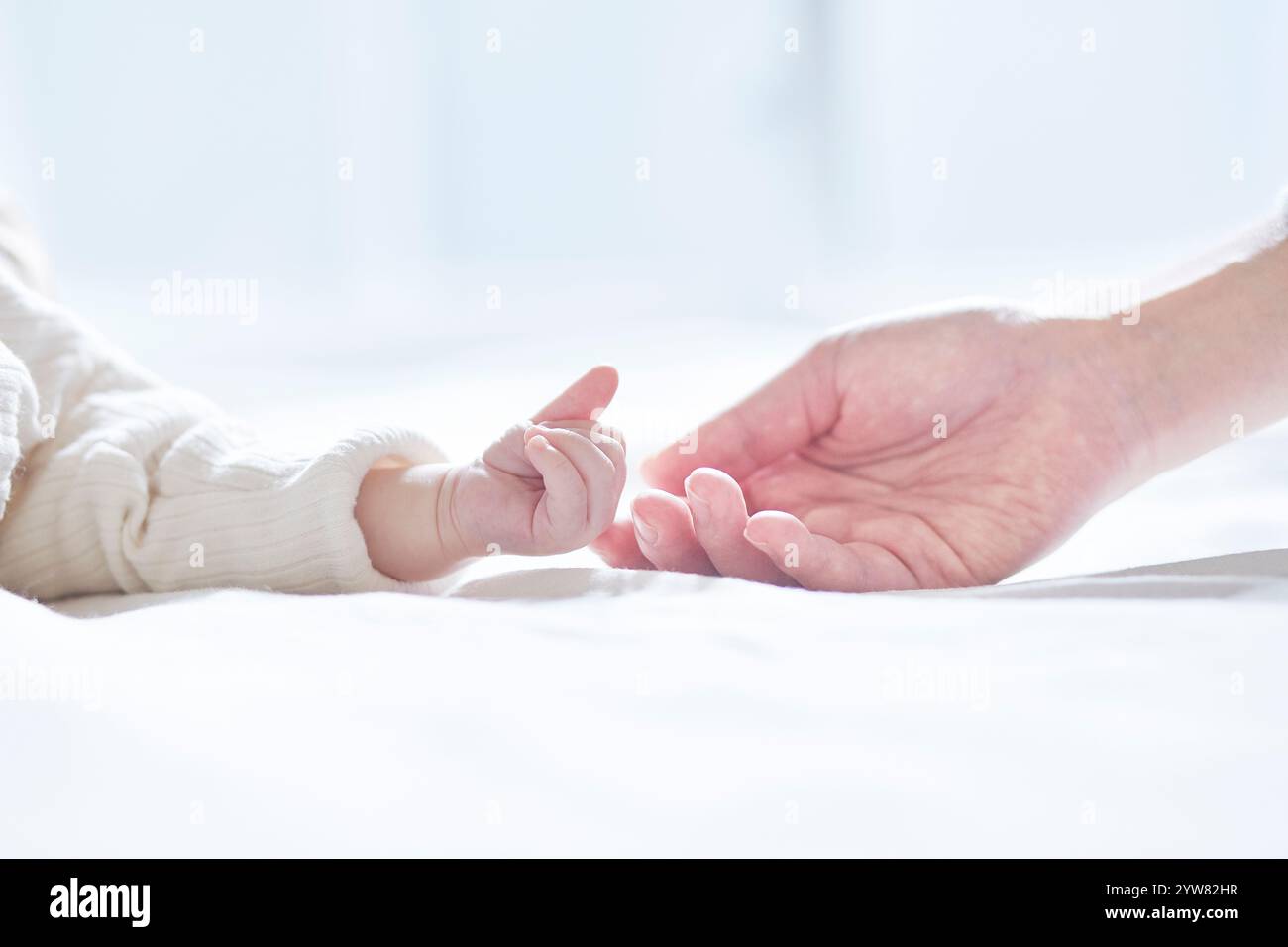 Baby's hand and mother's hand Stock Photo - Alamy