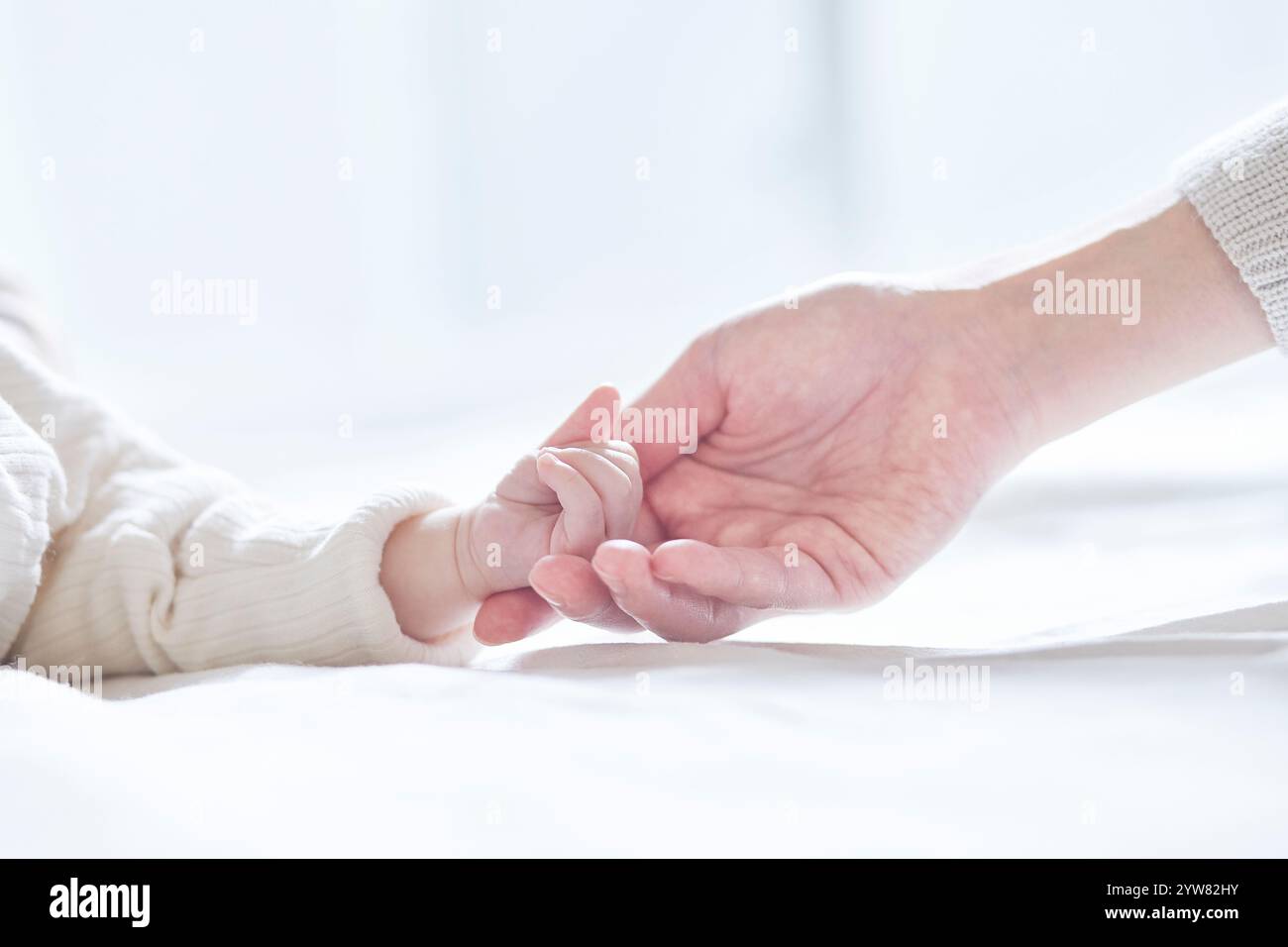 Baby's hand and mother's hand Stock Photo - Alamy
