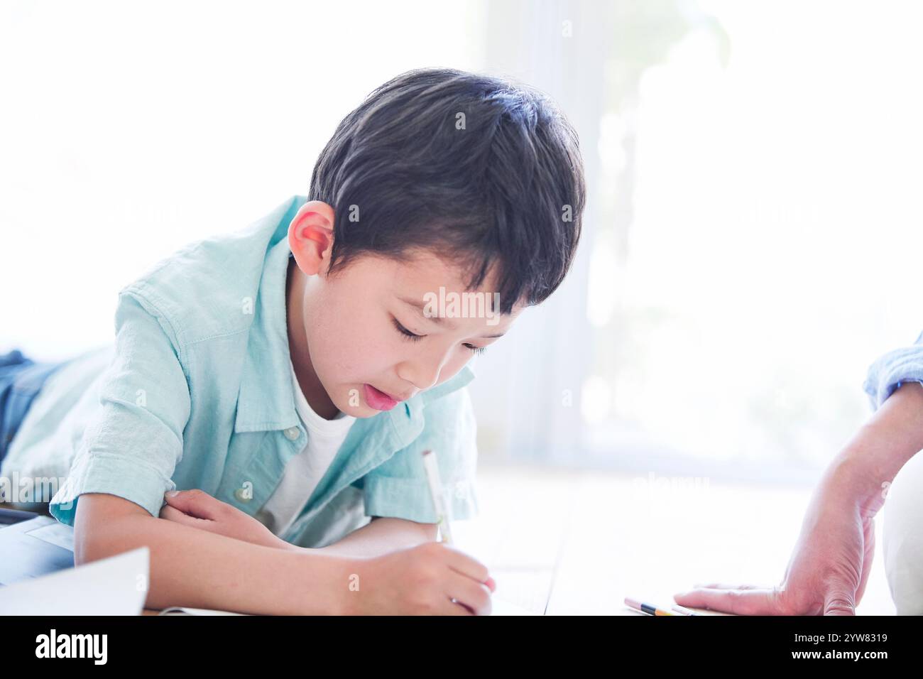 Boy with pen and mother Stock Photo - Alamy