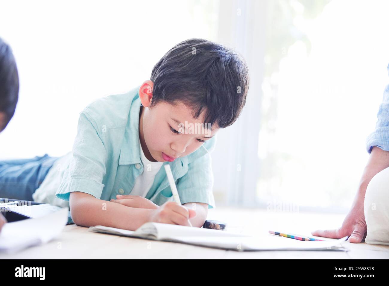 Boy with pen and mother Stock Photo - Alamy