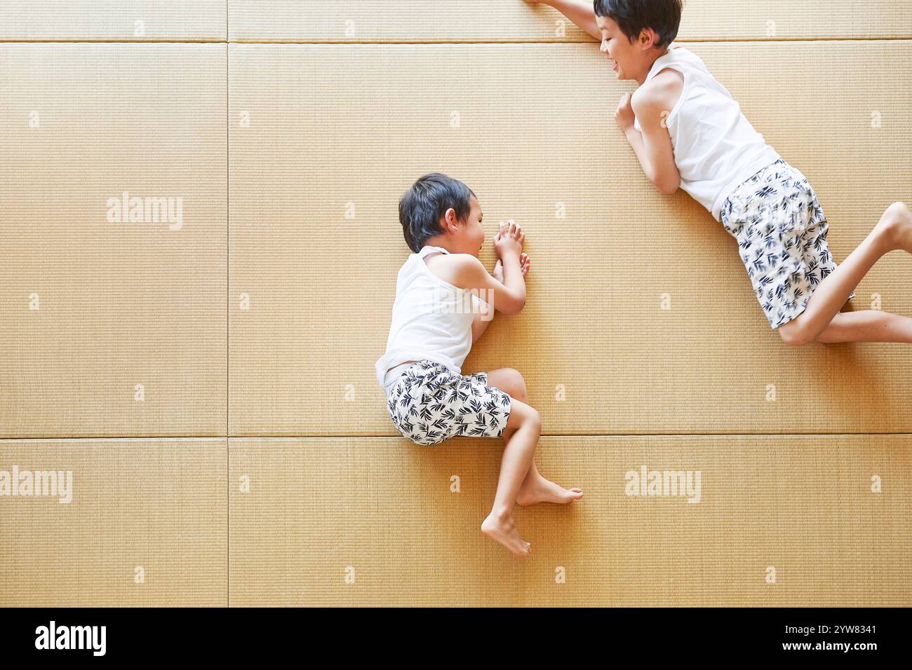 Boy lying on tatami mats Stock Photo - Alamy
