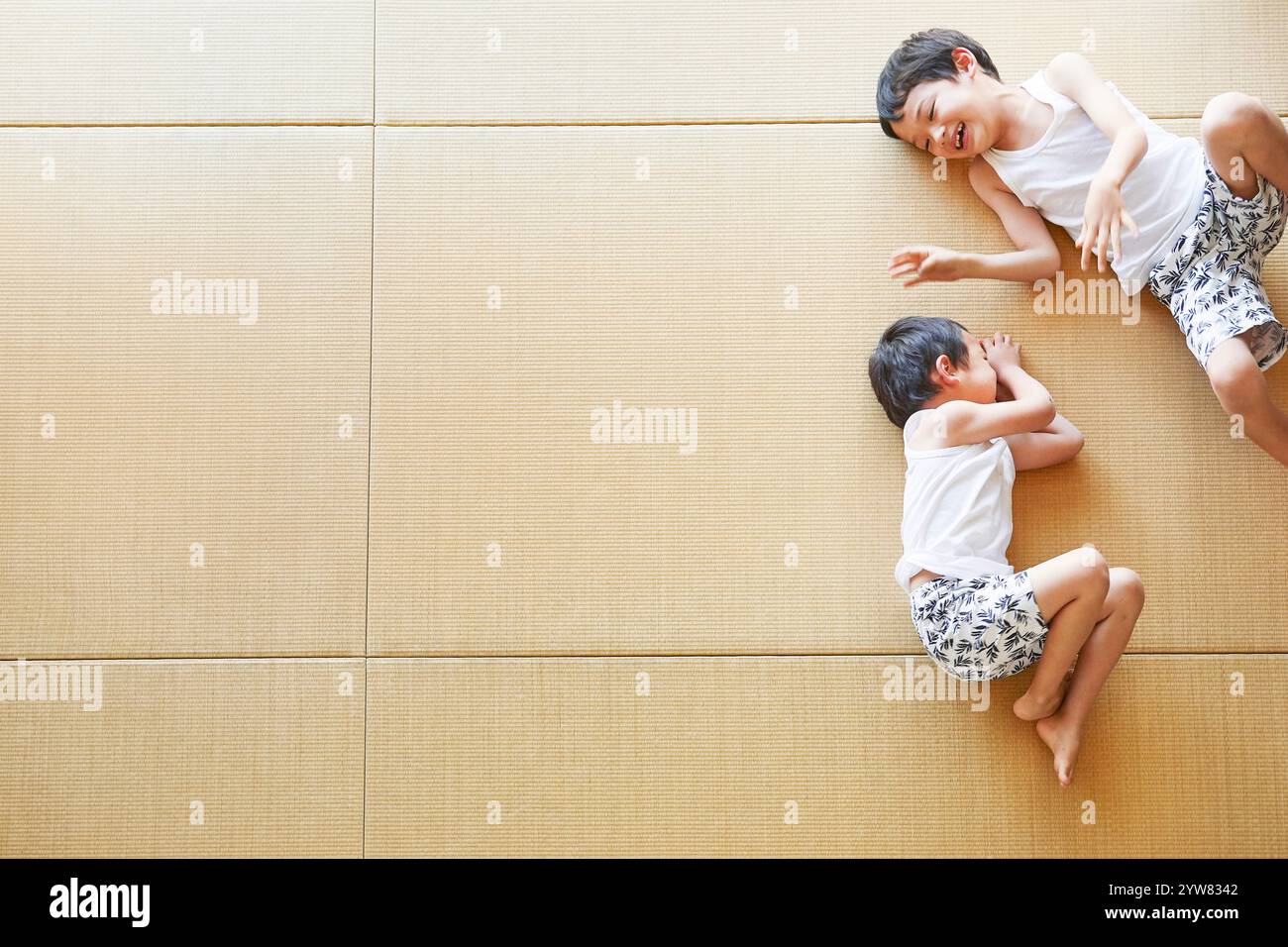 Boy lying on tatami mats Stock Photo - Alamy