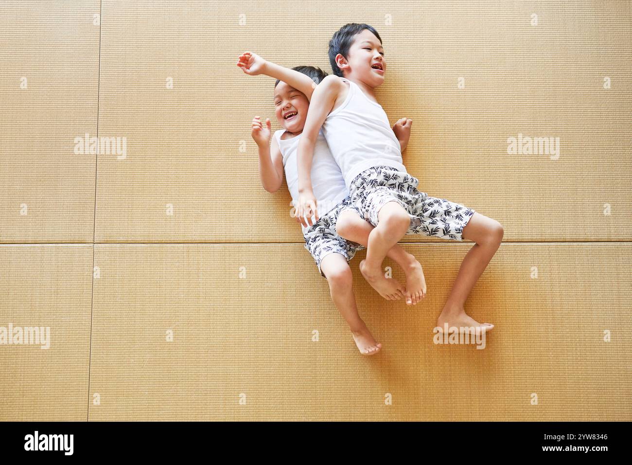 Boy lying on tatami mats Stock Photo - Alamy