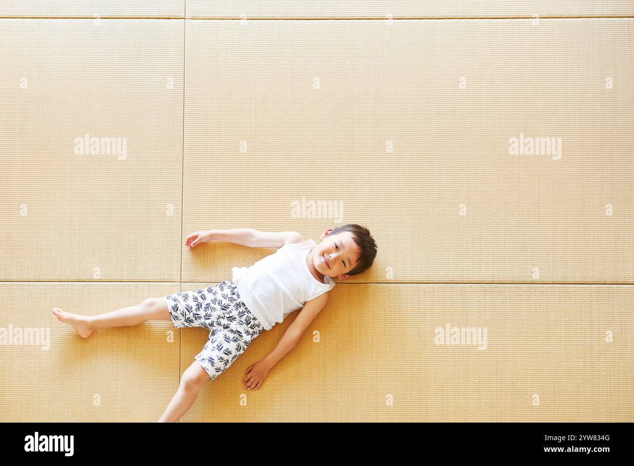 Boy lying on tatami mats Stock Photo - Alamy