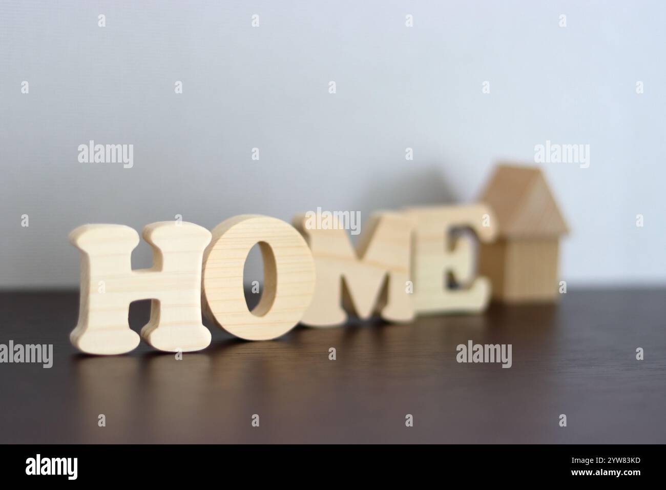 Wooden word blocks representing house-shaped blocks and the word HOME ...