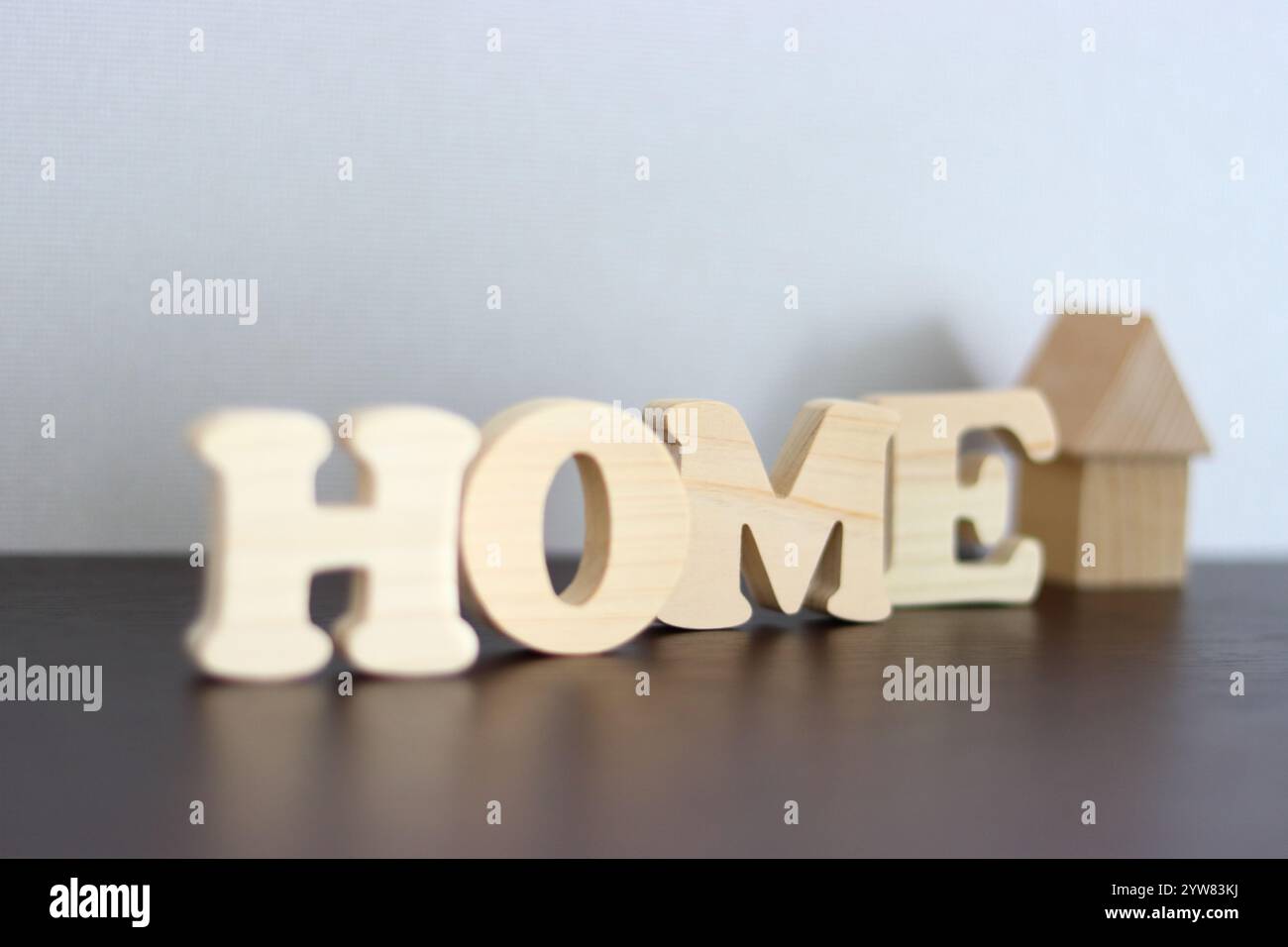 Wooden word blocks representing house-shaped blocks and the word HOME ...