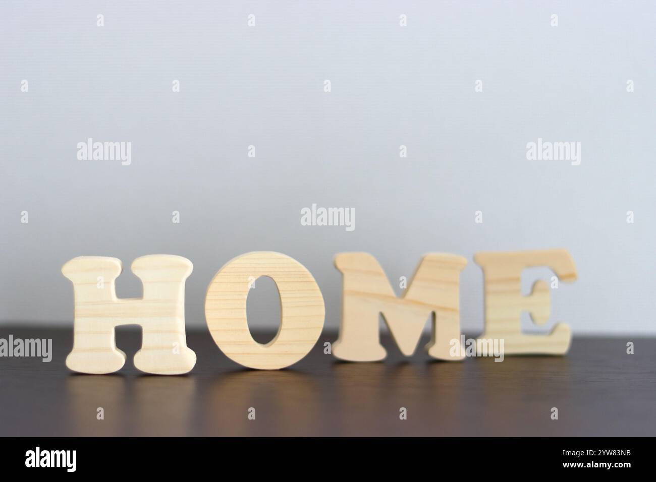 Wooden word blocks representing the letters HOME Stock Photo - Alamy