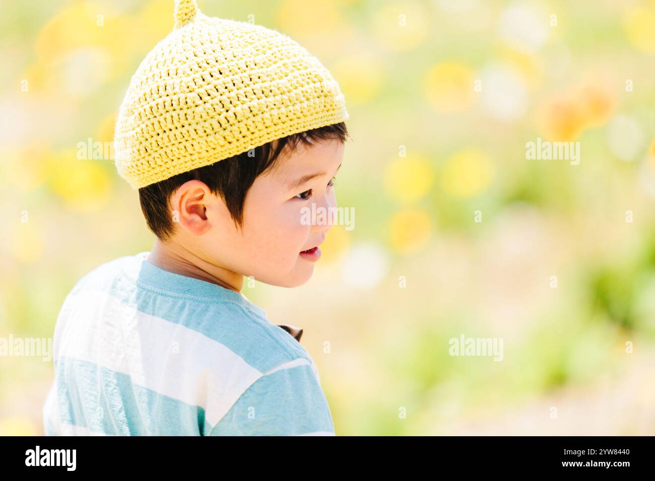 Boy turning sideways in flower garden Stock Photo - Alamy