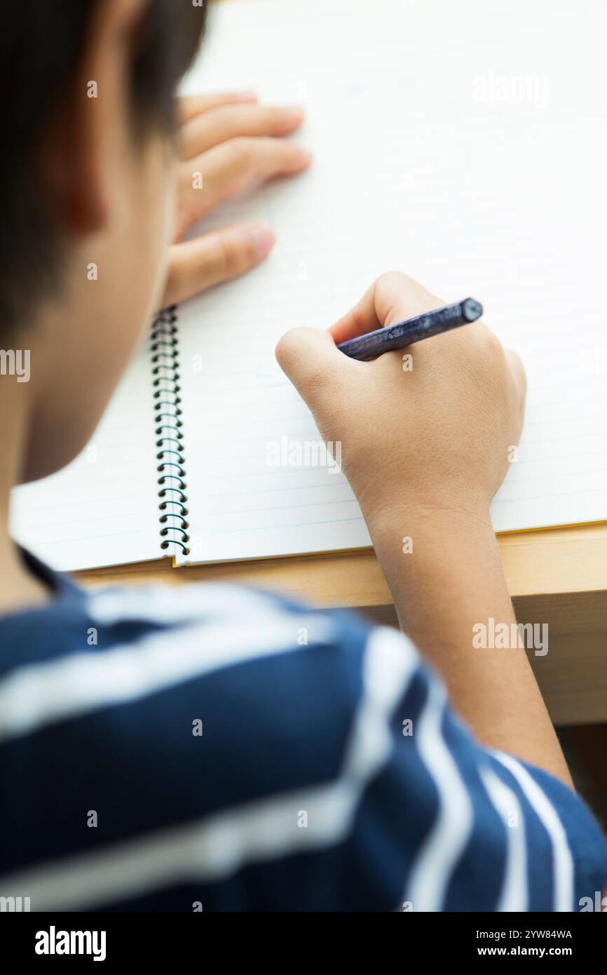 Hand of a boy of primary school age writing a picture Stock Photo - Alamy