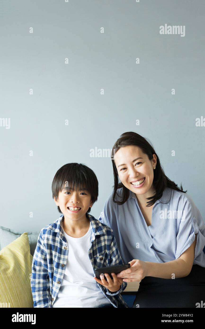 Woman and boys operating tablet Stock Photo - Alamy