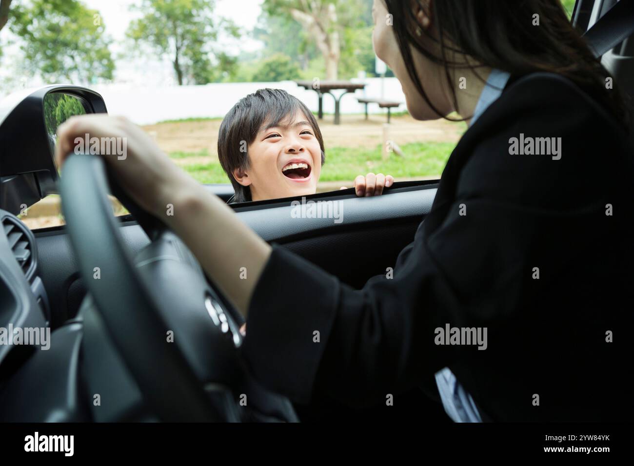 Woman driving her child to and from school Stock Photo - Alamy