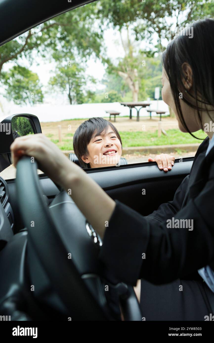 Woman driving her child to and from school Stock Photo - Alamy