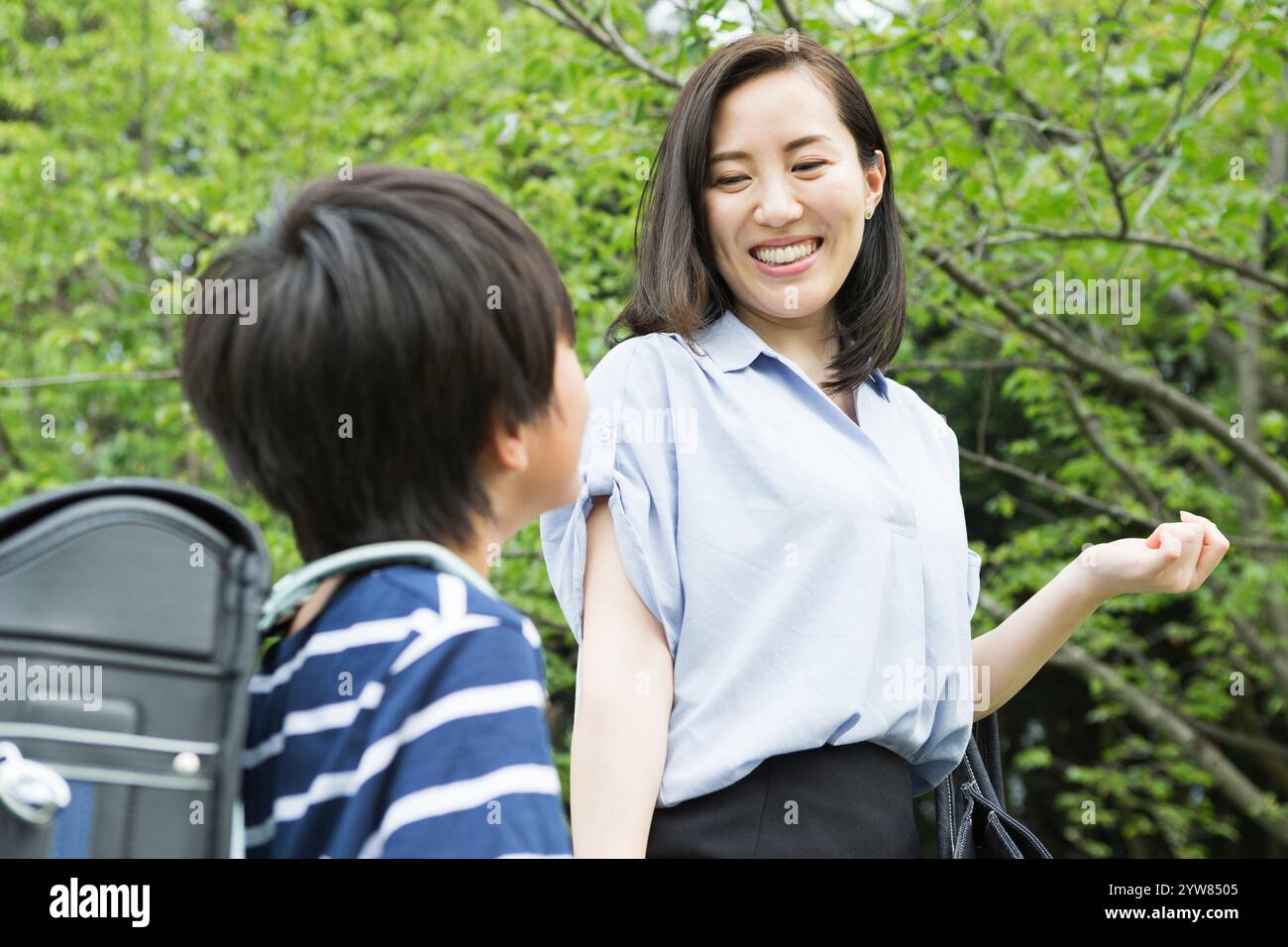 Smiling mother talking with her primary schools son Stock Photo - Alamy