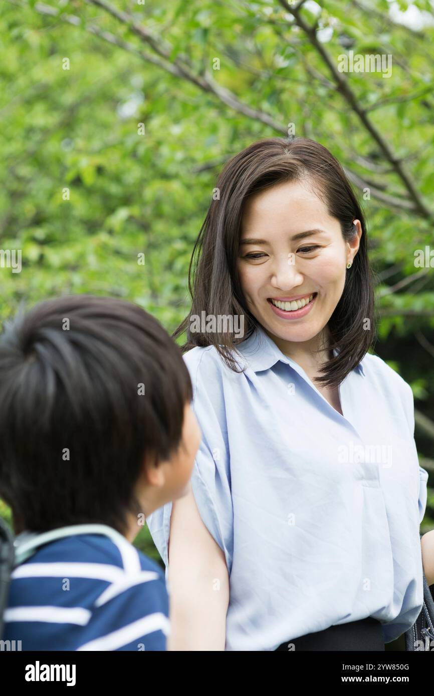 Smiling mother talking to her son Stock Photo - Alamy