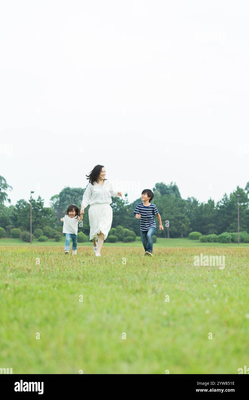 Parent and child running hand in hand with a smile Stock Photo - Alamy