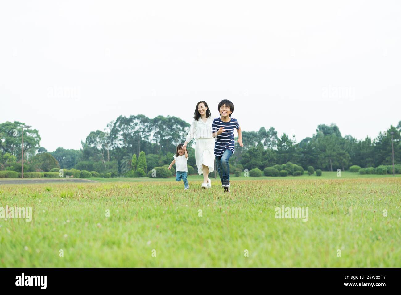 Parent and child running hand in hand with a smile Stock Photo - Alamy