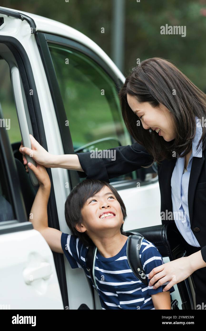 Woman driving her child to and from school Stock Photo - Alamy