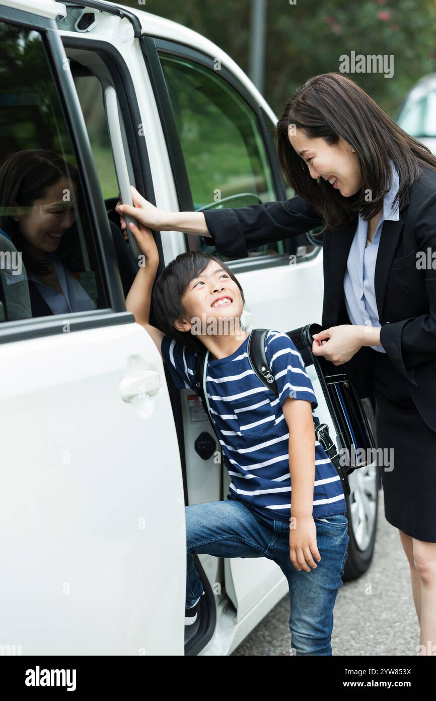 Woman driving her child to and from school Stock Photo - Alamy
