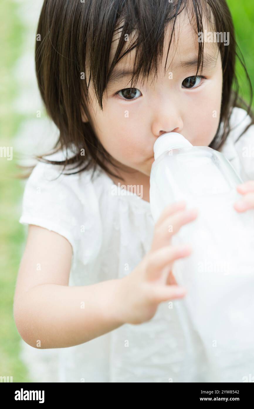 Girls drinking water Stock Photo - Alamy