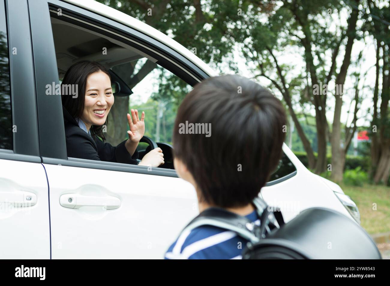 Woman driving her child to and from school Stock Photo - Alamy