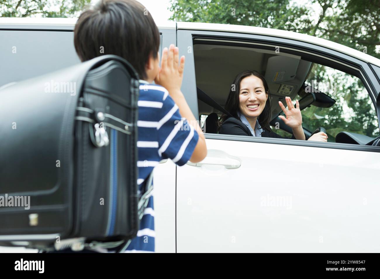 Woman driving her child to and from school Stock Photo - Alamy