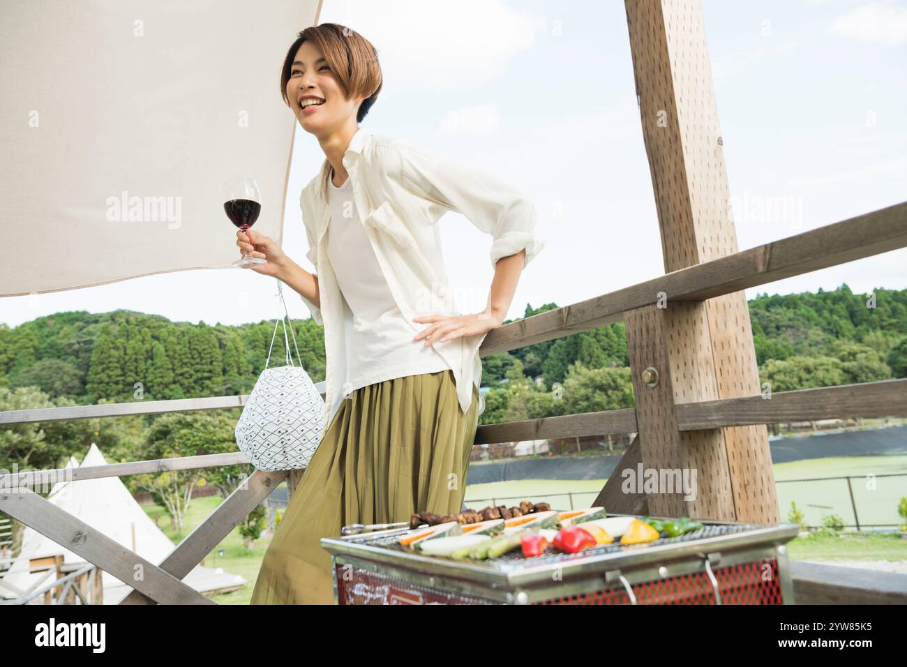 Woman in her 20s enjoying a barbecue Stock Photo - Alamy