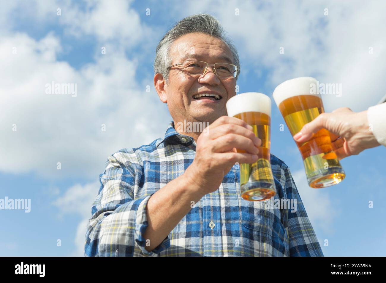 Senior man toasting with beer Stock Photo - Alamy