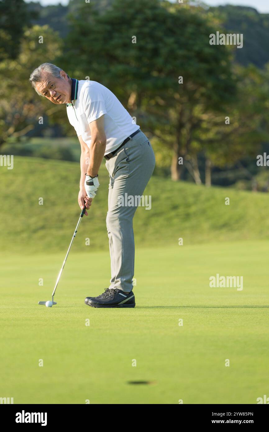 Senior men playing golf Stock Photo - Alamy