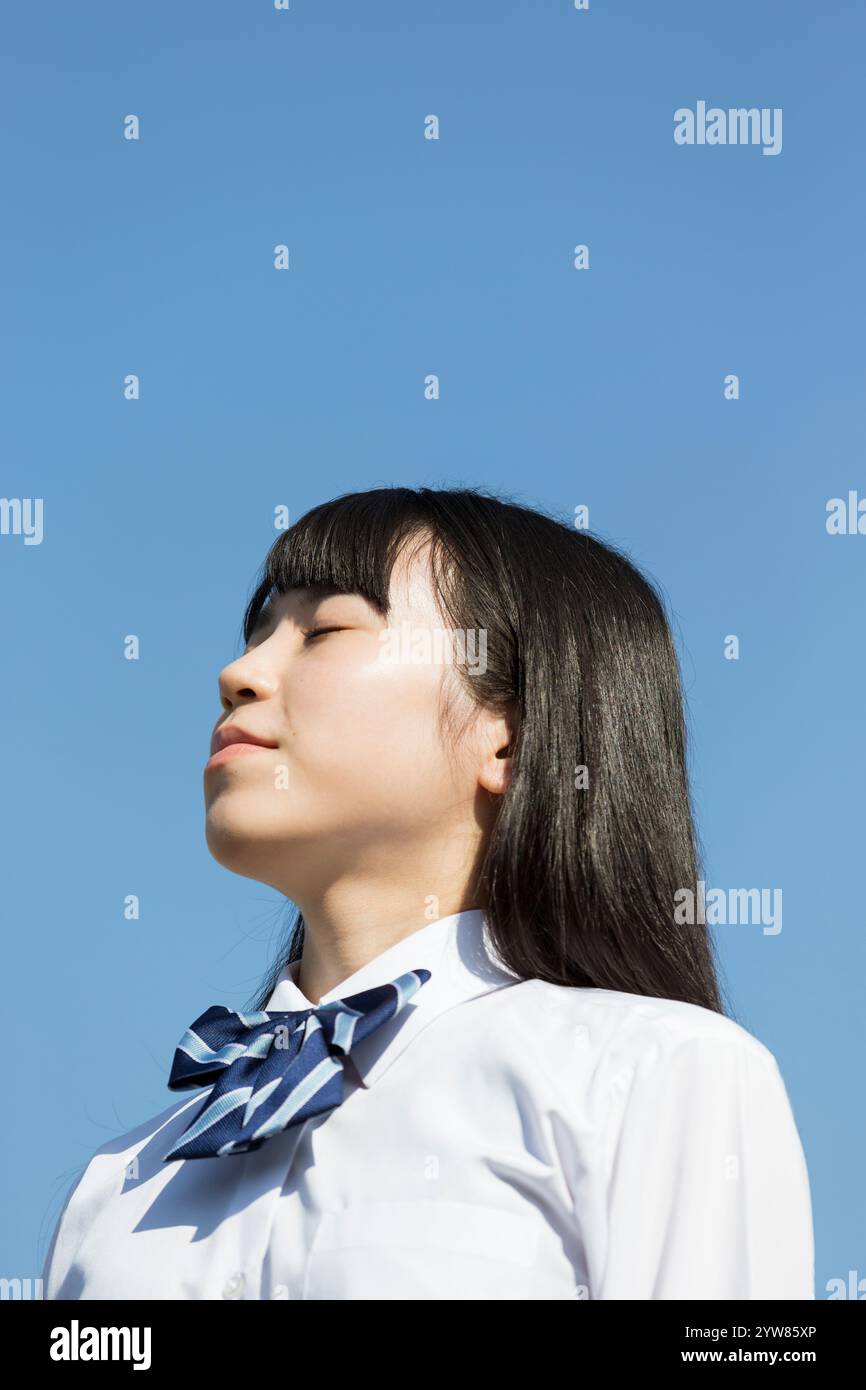 High school girl closing her eyes Stock Photo - Alamy