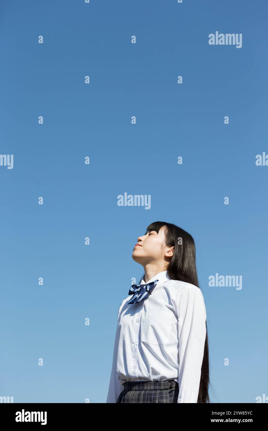 High school girl closing her eyes Stock Photo - Alamy