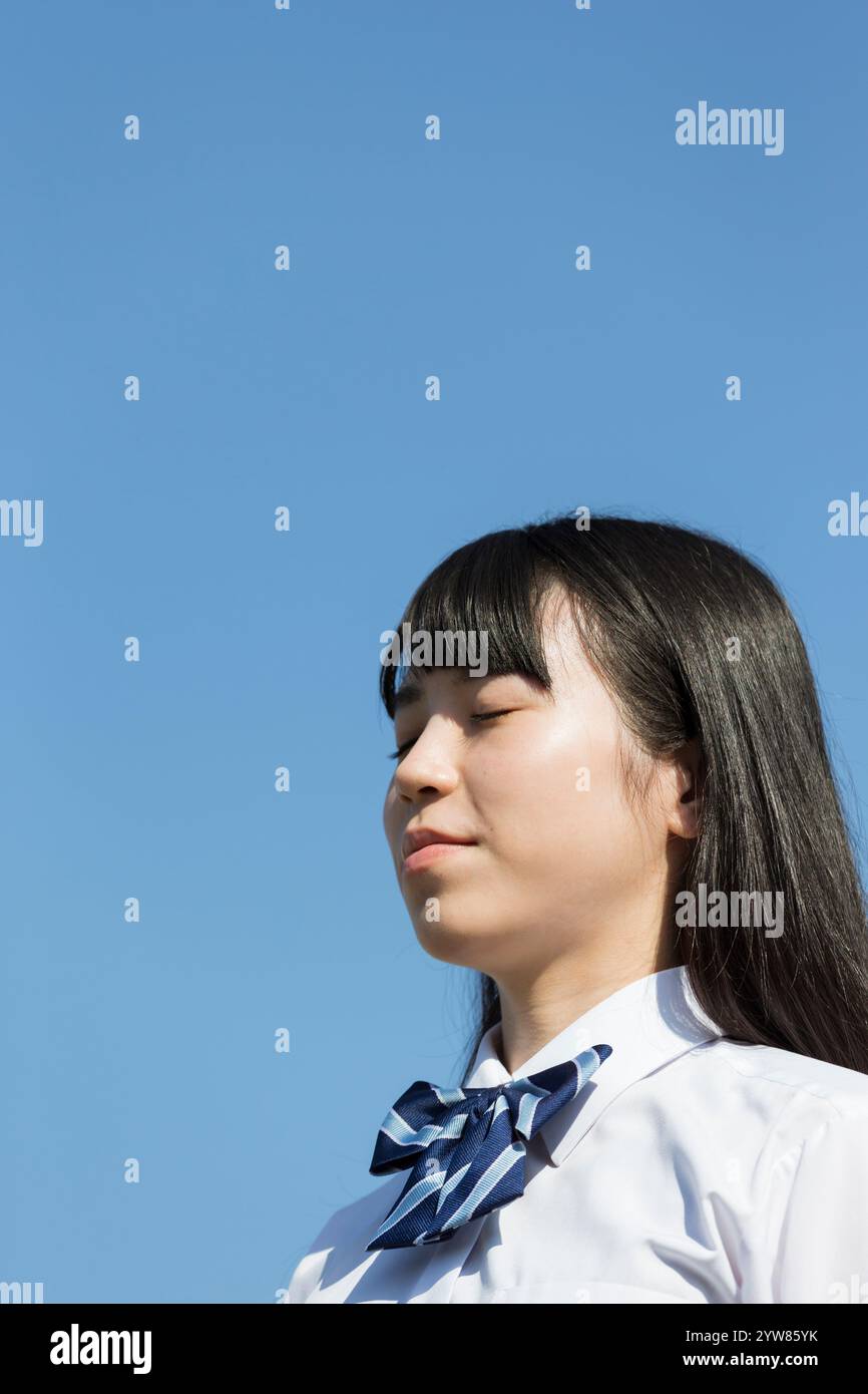 High school girl closing her eyes Stock Photo - Alamy