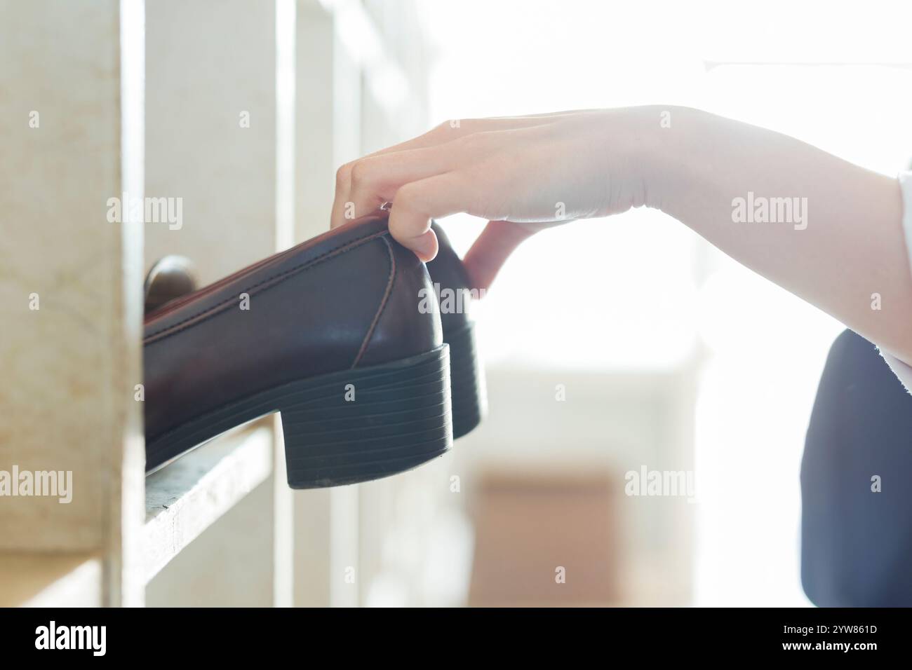 Hand of high school girl putting shoes into geta box Stock Photo - Alamy