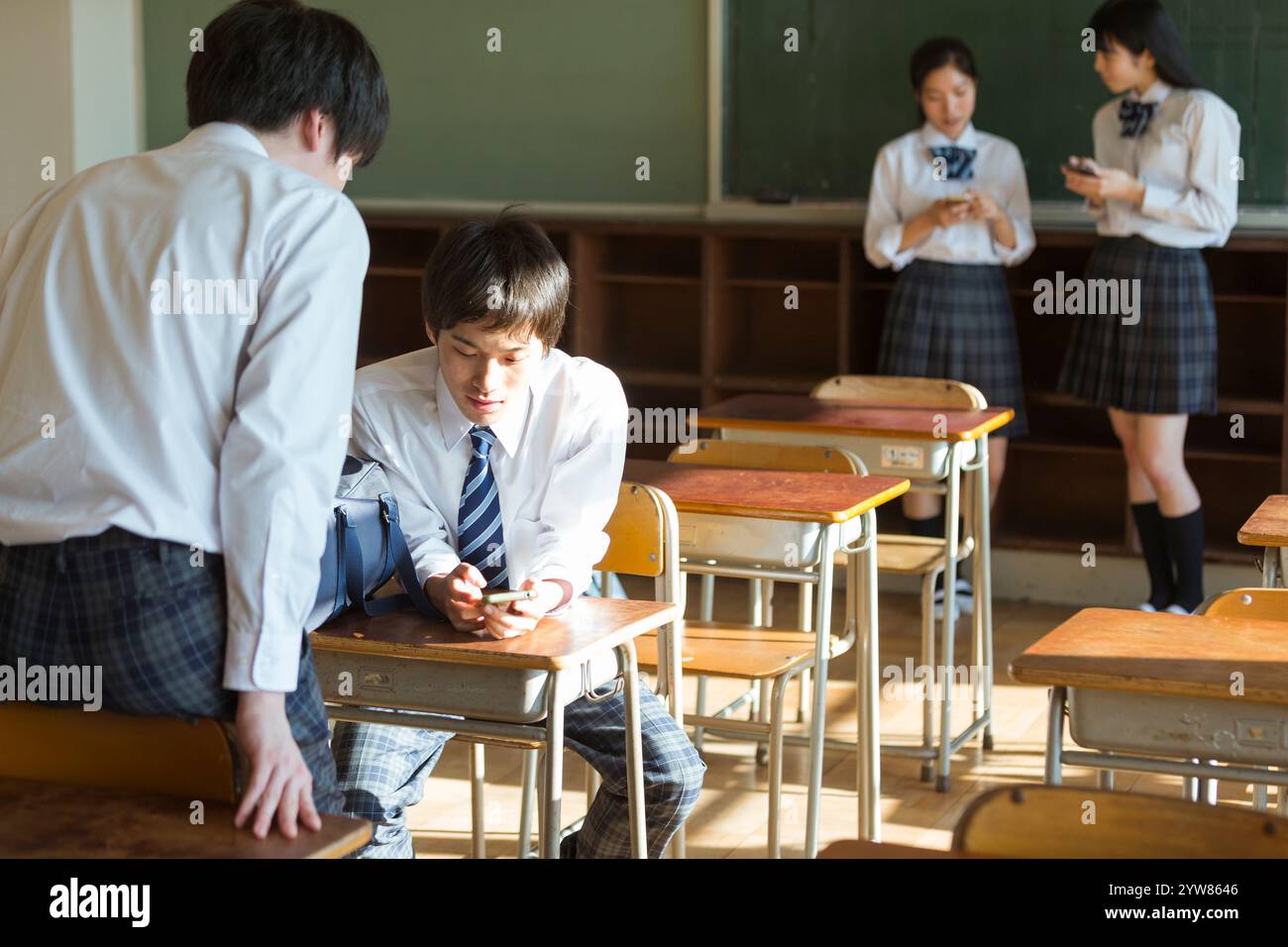 High school student operating a smartphone in the classroom Stock Photo ...