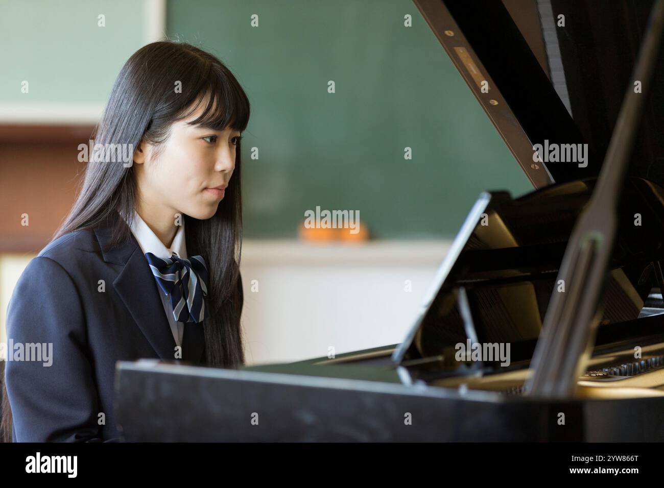 High school girl playing piano Stock Photo - Alamy