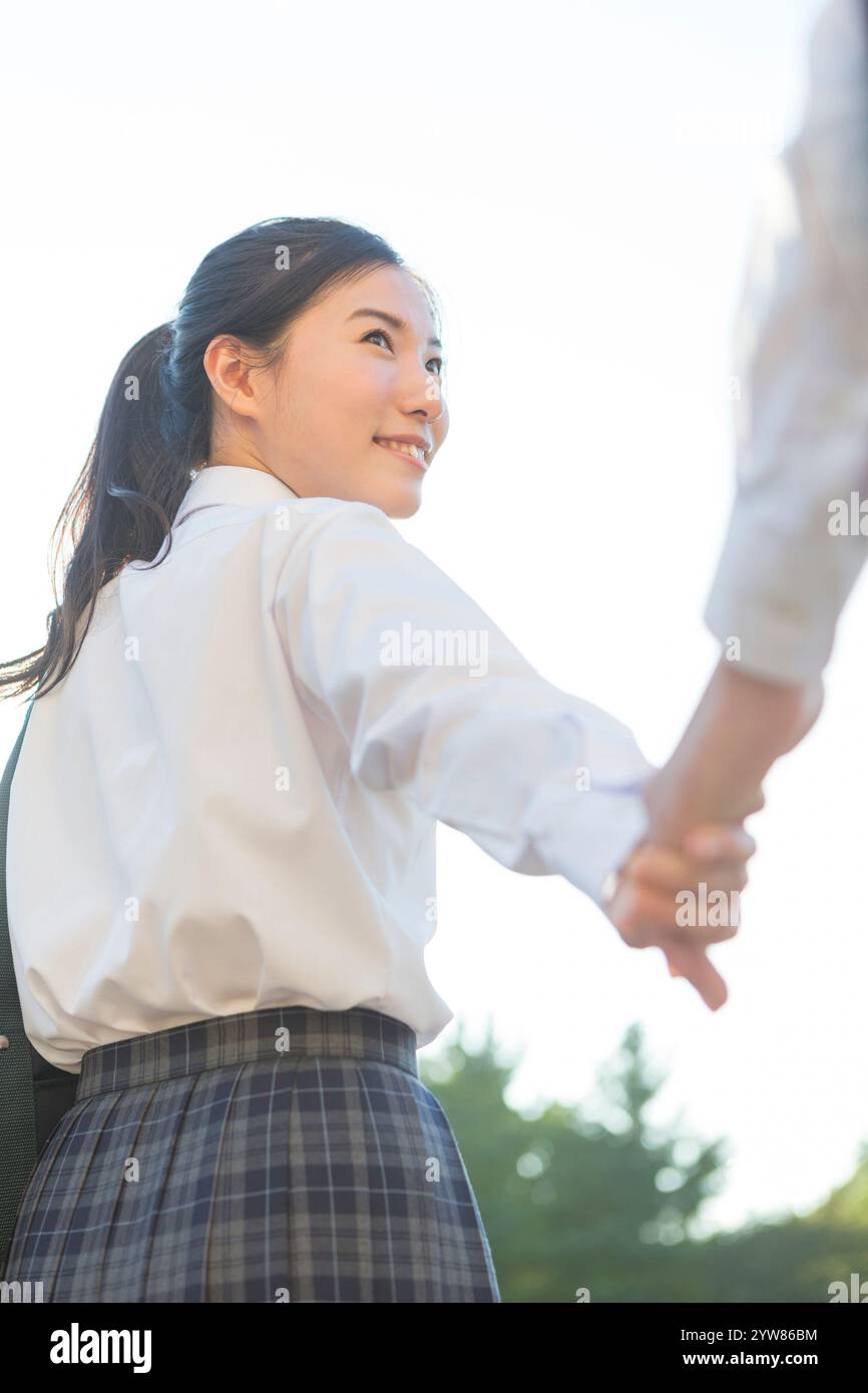 High school girls pulling hands Stock Photo - Alamy