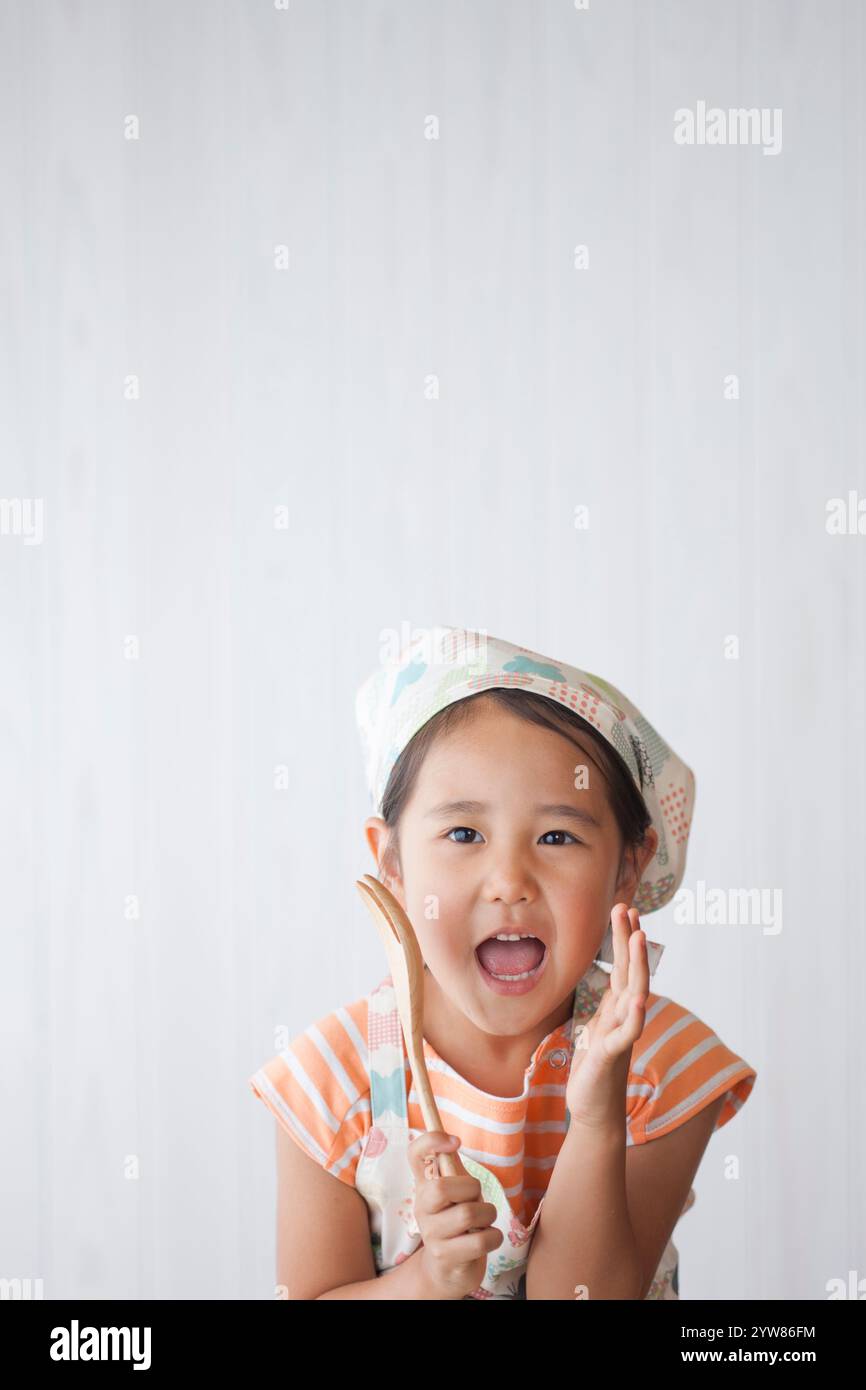 Girl posing with kitchen utensils Stock Photo - Alamy