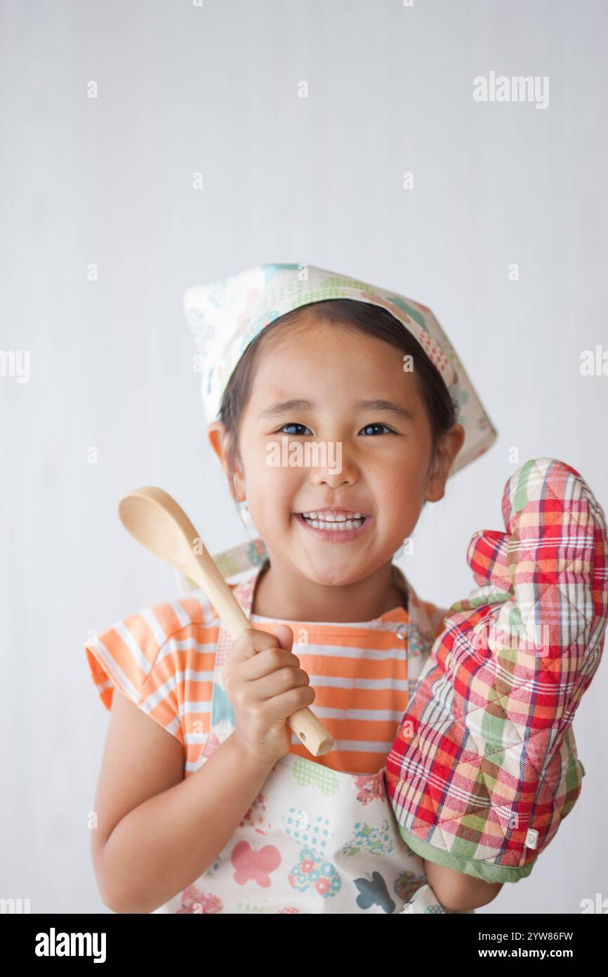 Girl posing with kitchen utensils Stock Photo - Alamy