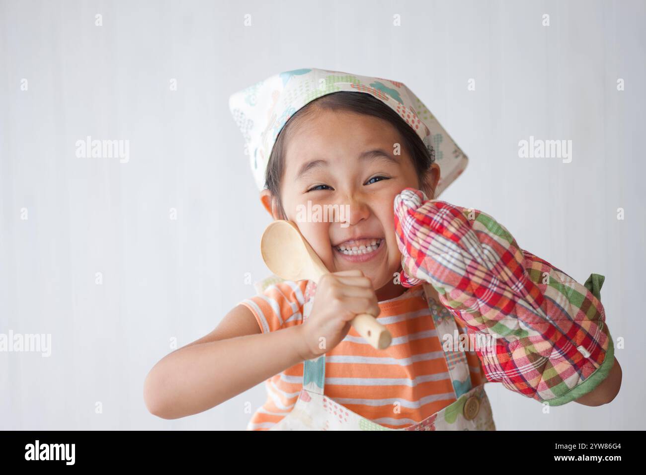 Girl posing with kitchen utensils Stock Photo - Alamy