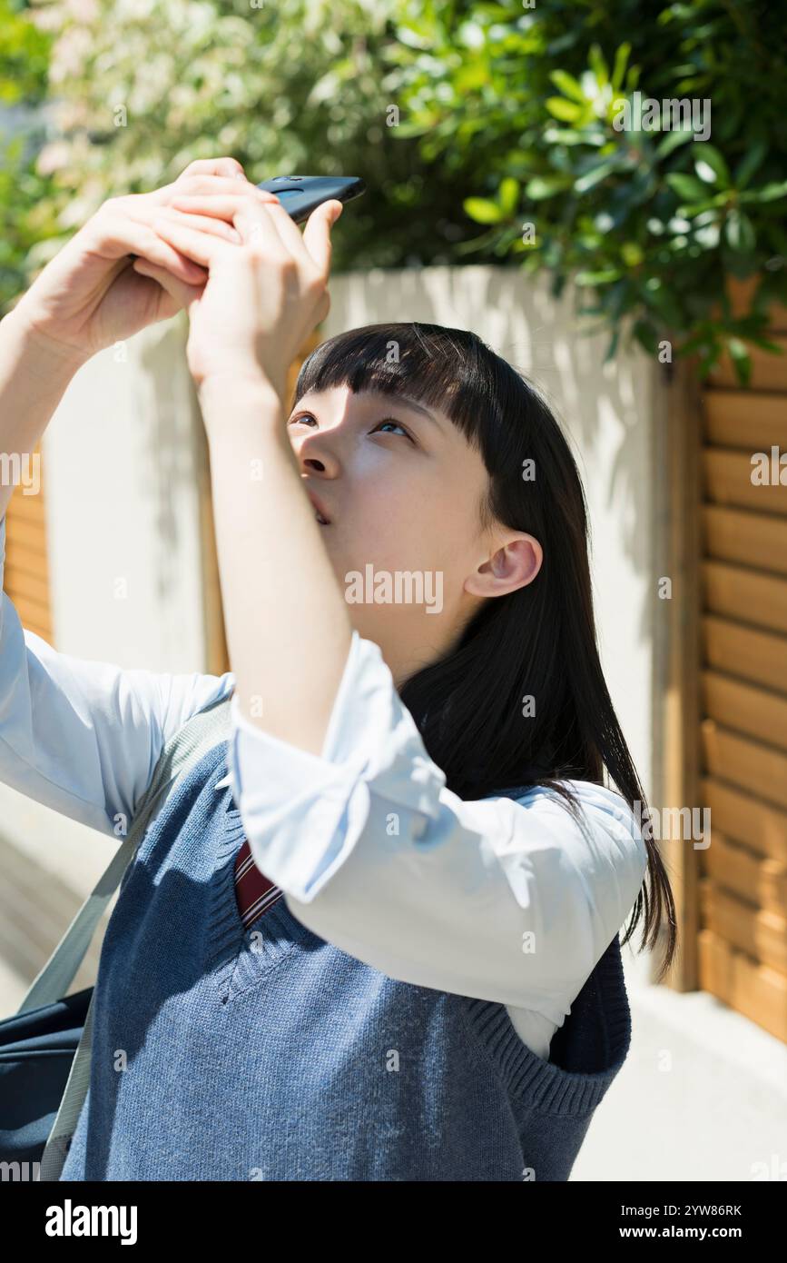 Female high school student Smartphone Flowers Shooting Stock Photo - Alamy