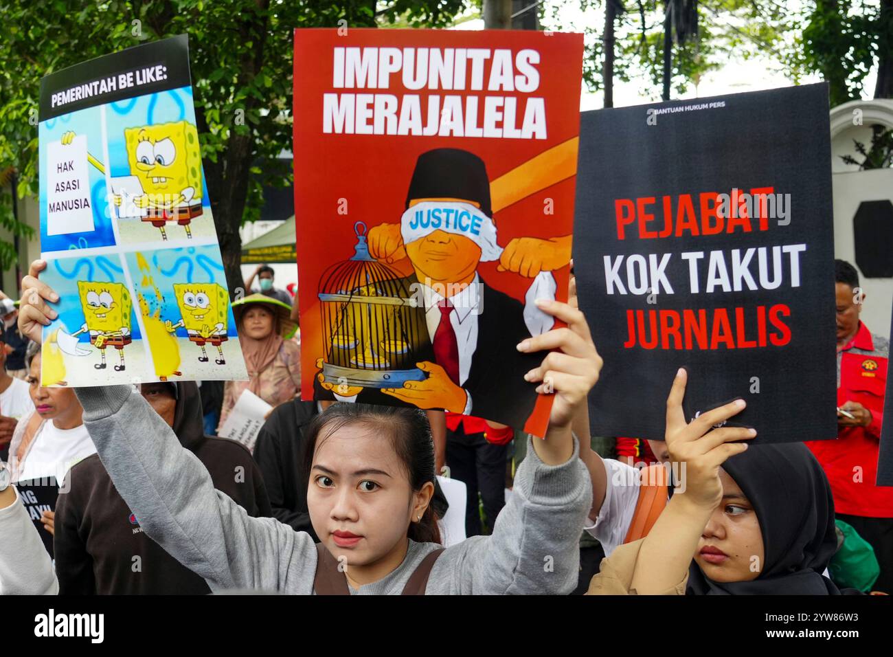 Protesters hold posters during a demonstration commemorating the ...