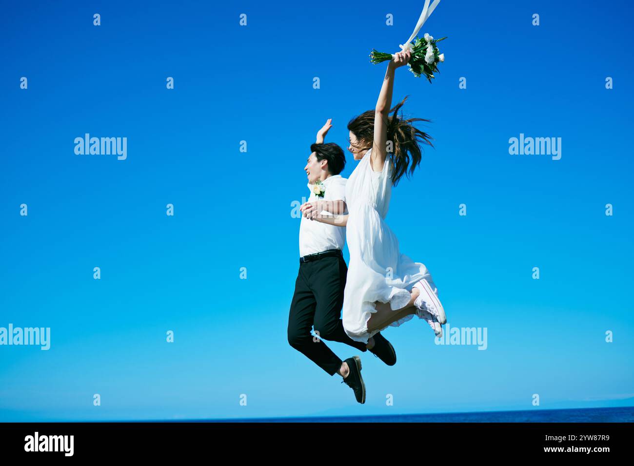 Wedding Jumping Blue sky Stock Photo - Alamy