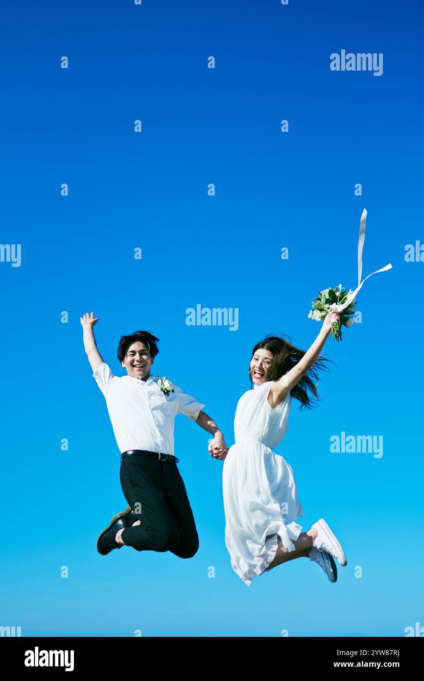 Wedding Jumping Blue sky Stock Photo - Alamy