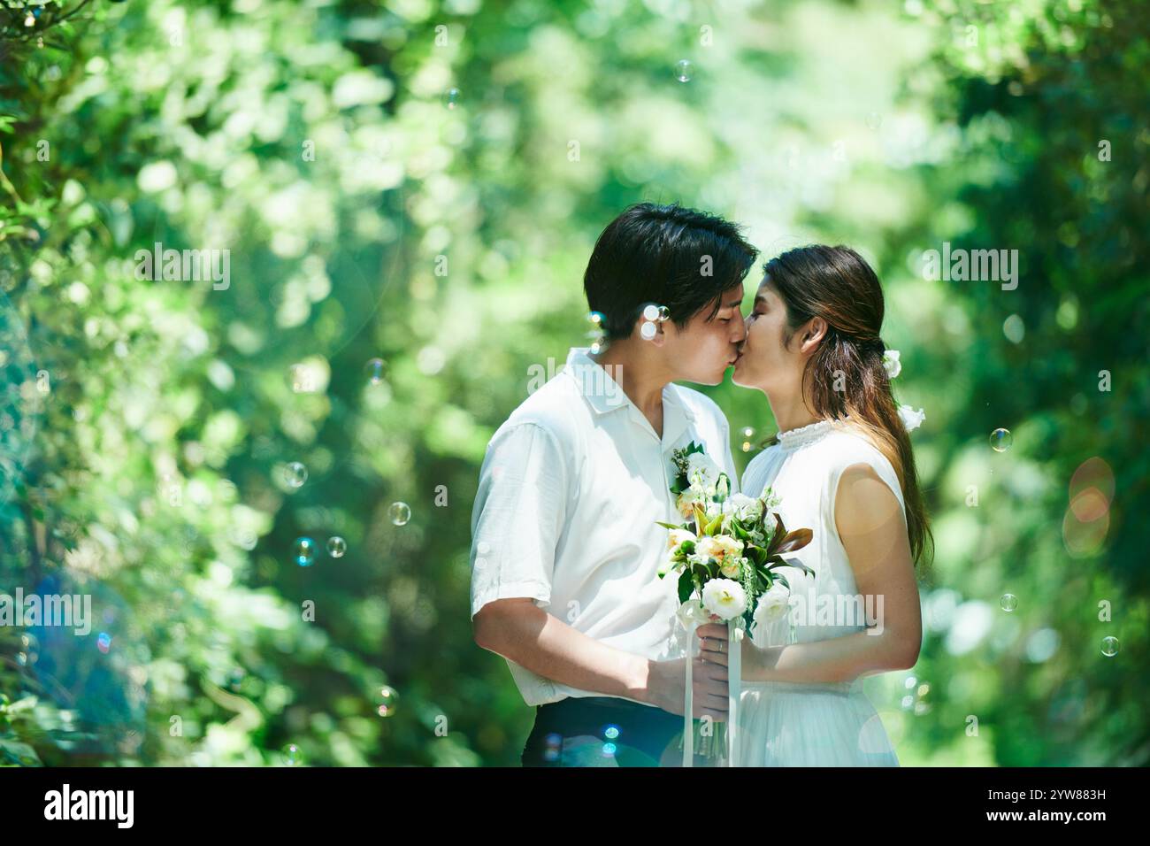 Wedding Couple Kissing Stock Photo - Alamy
