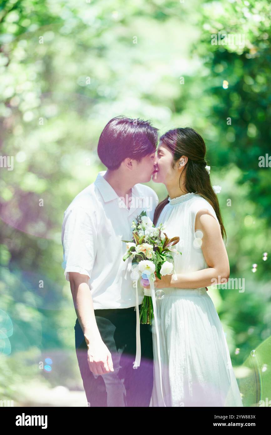 Wedding Couple Kissing Stock Photo - Alamy