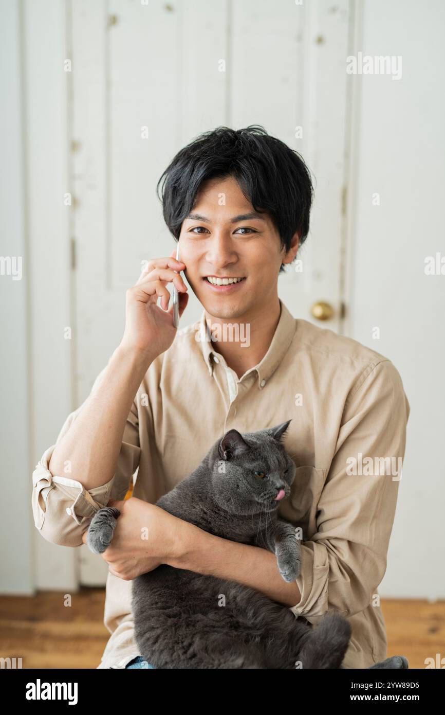 Man and cat working remotely Stock Photo - Alamy
