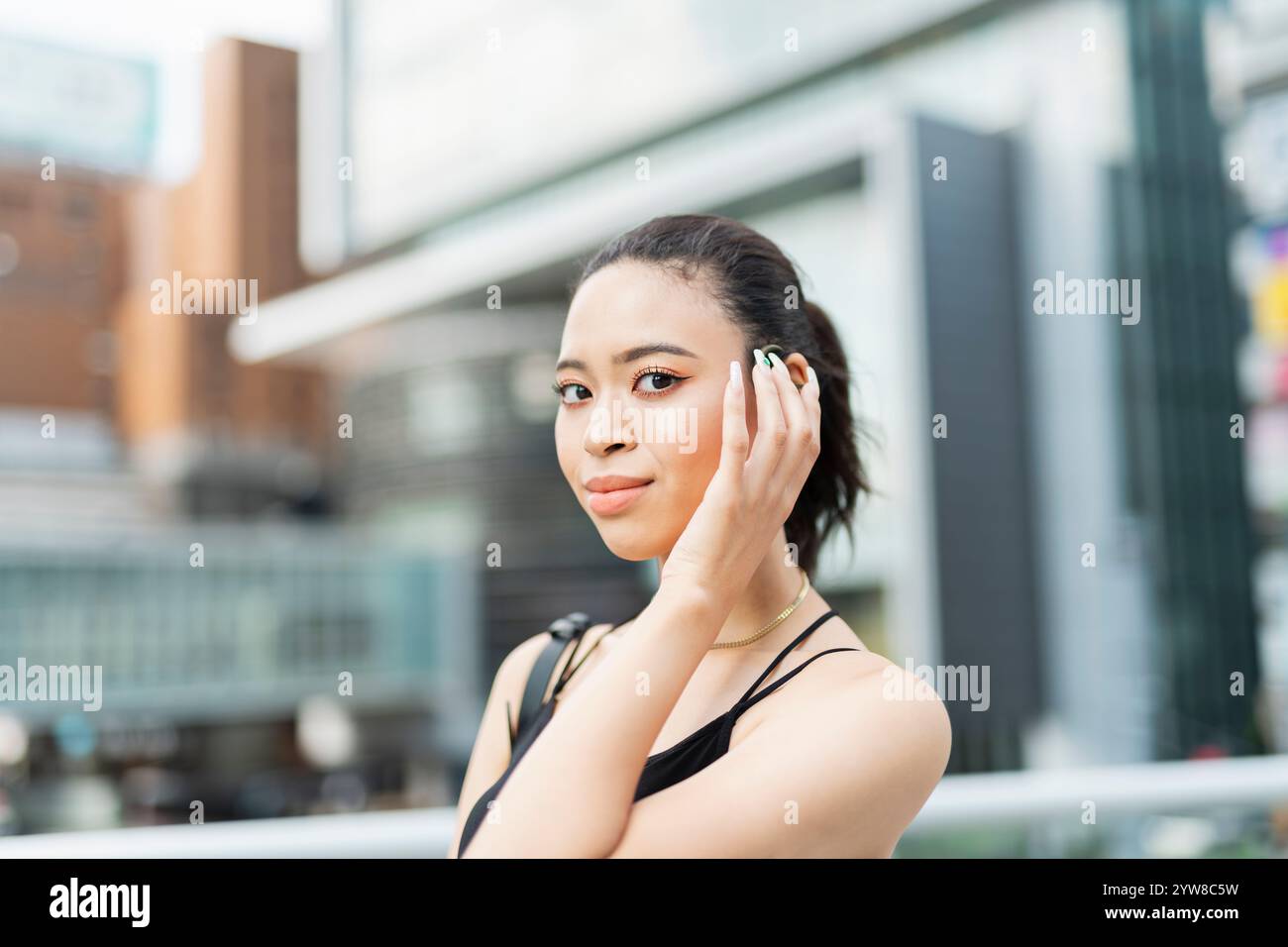 Mixed Japanese and black women listening to music Stock Photo - Alamy
